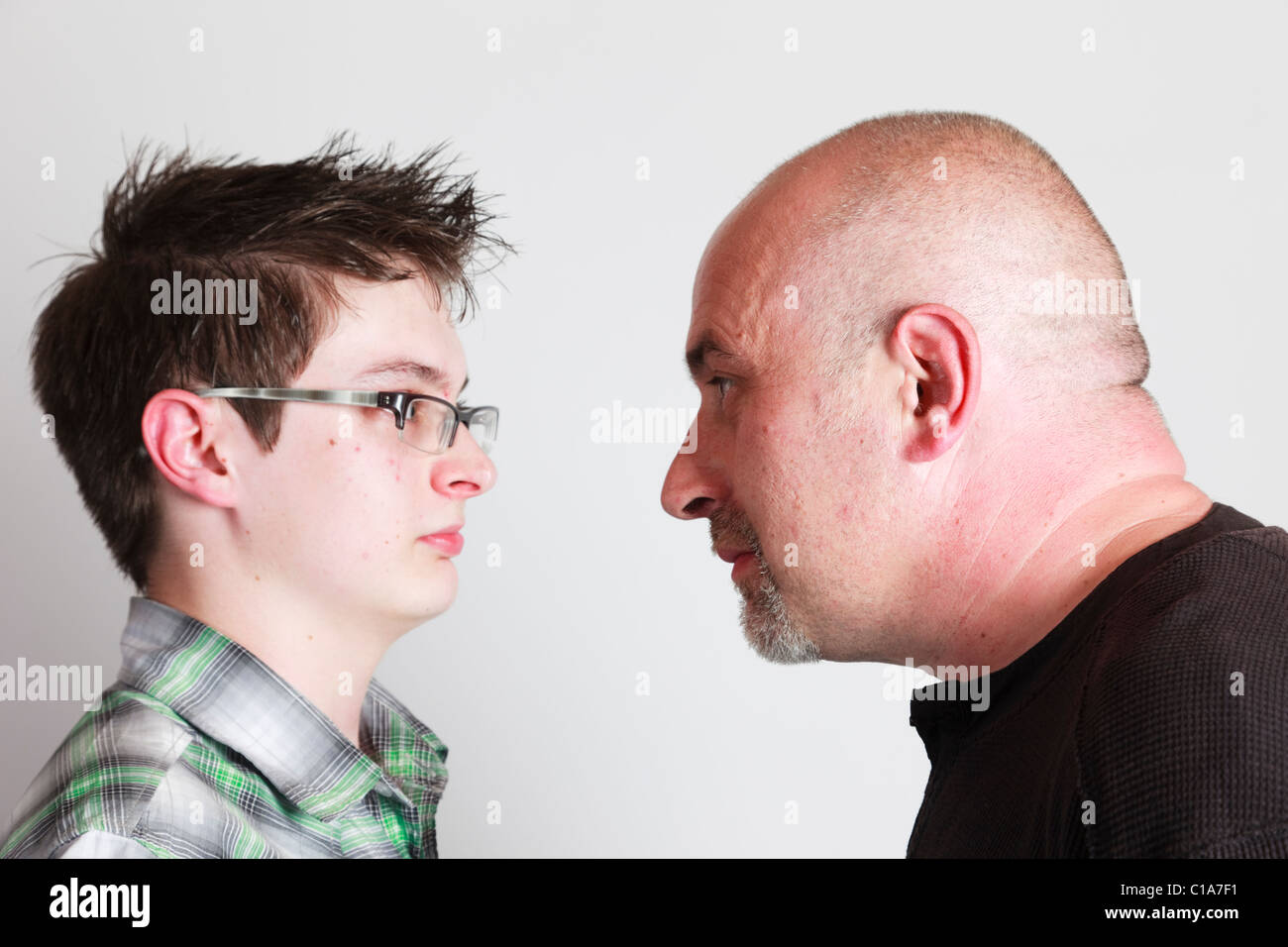 UK, Europe. Head and shoulders portrait of a father and teenage son ...