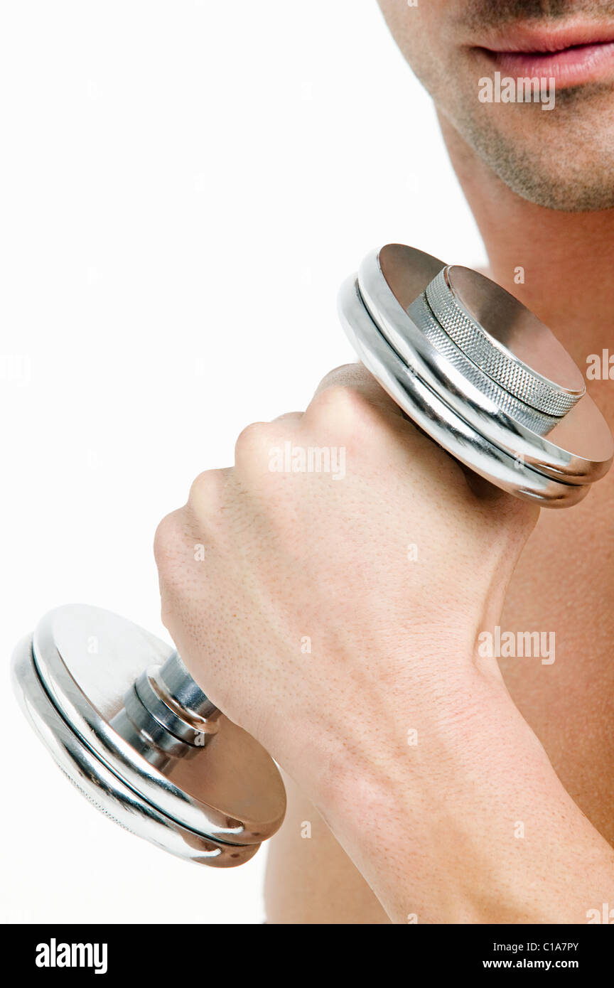 Young man with hand weights Stock Photo - Alamy