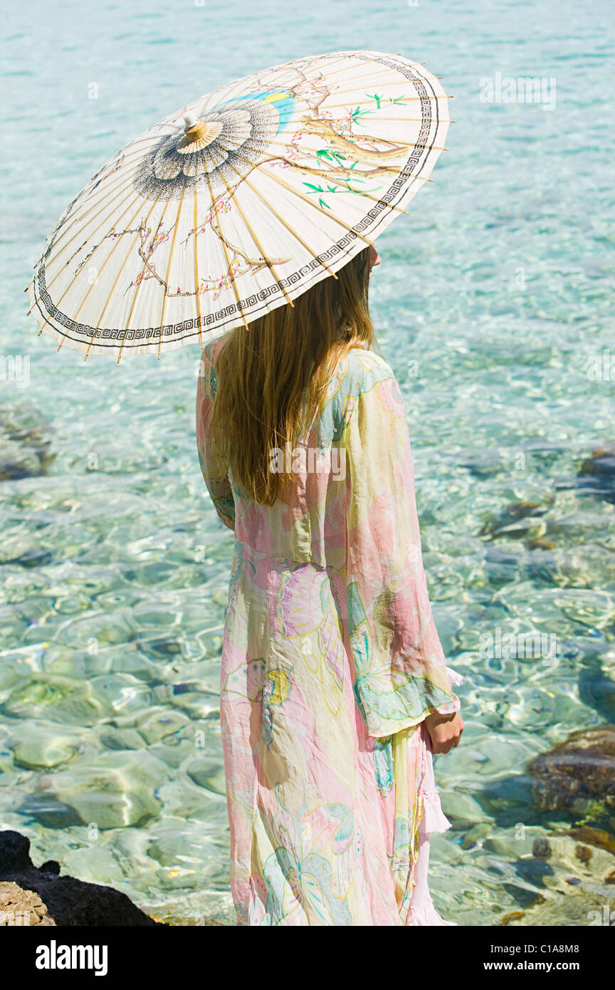 Young woman on vacation with parasol Stock Photo - Alamy