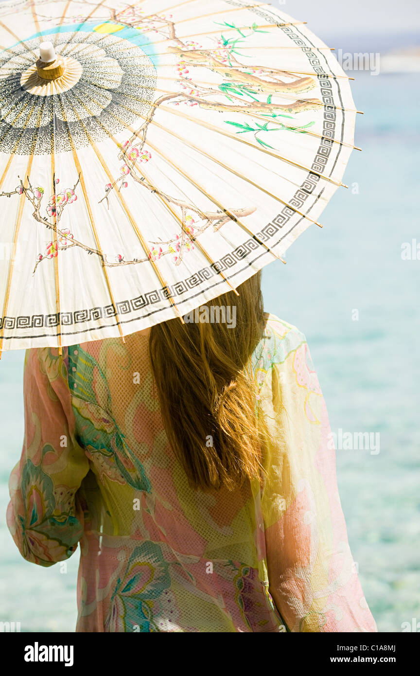 Young woman on vacation with parasol Stock Photo - Alamy
