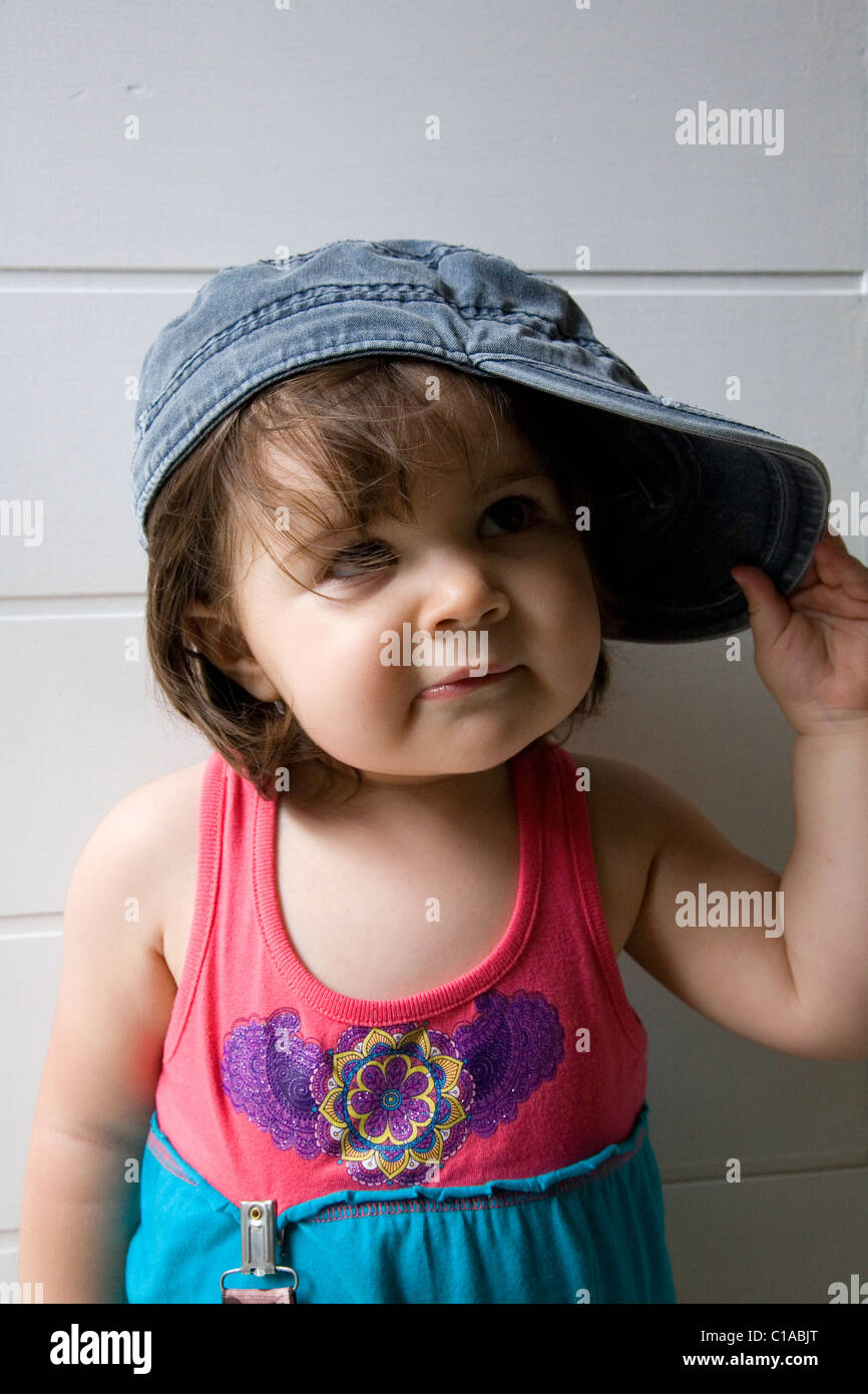 Girl with oversized cap on Stock Photo - Alamy