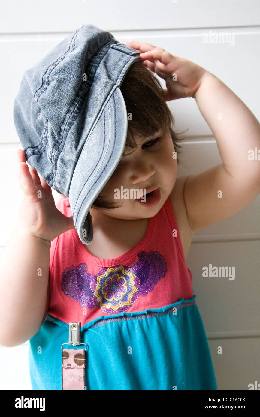Girl with oversized cap on Stock Photo - Alamy