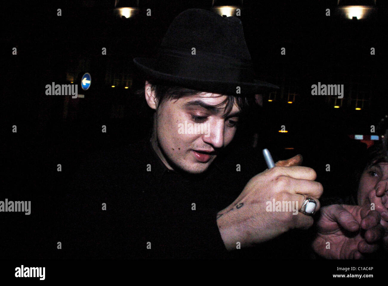 Pete Doherty signs autographs for fans after his performance at the ...