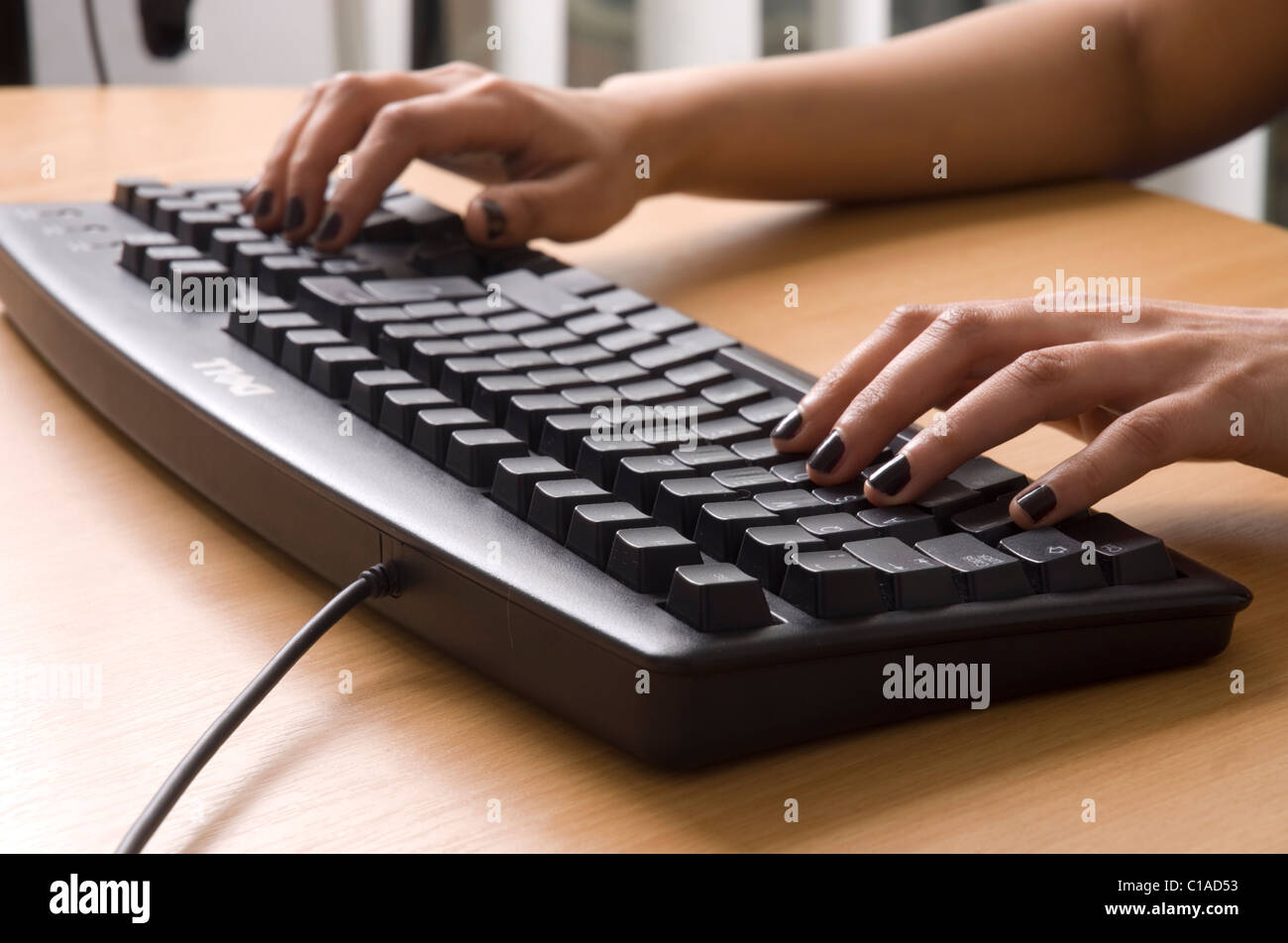 Typing on a computer keyboard Stock Photo - Alamy