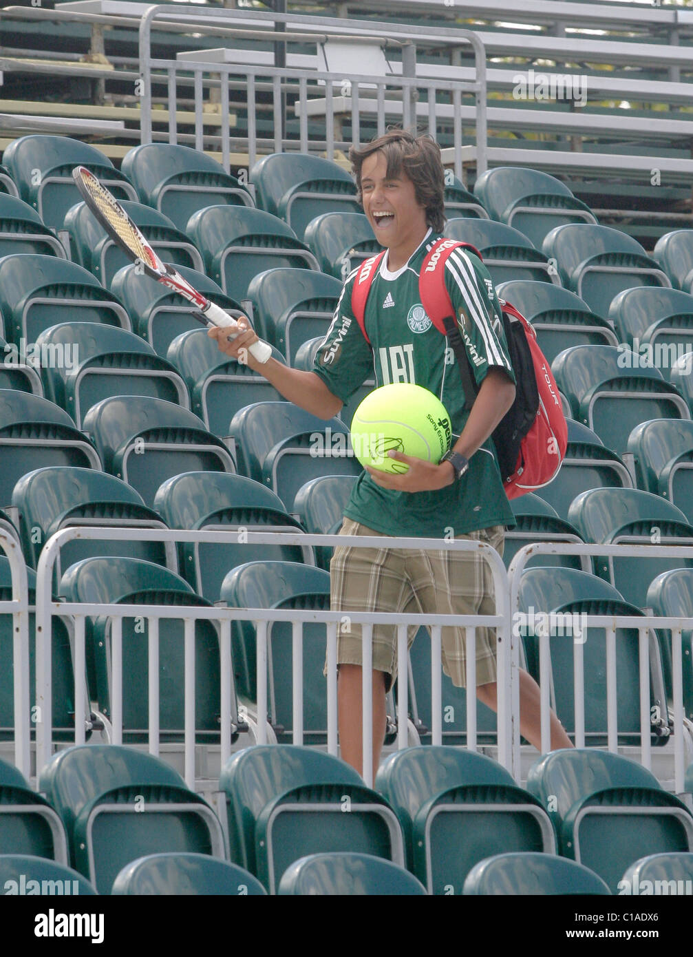 A spectator gets the broken racket as used by Marat Safin Practice for ...
