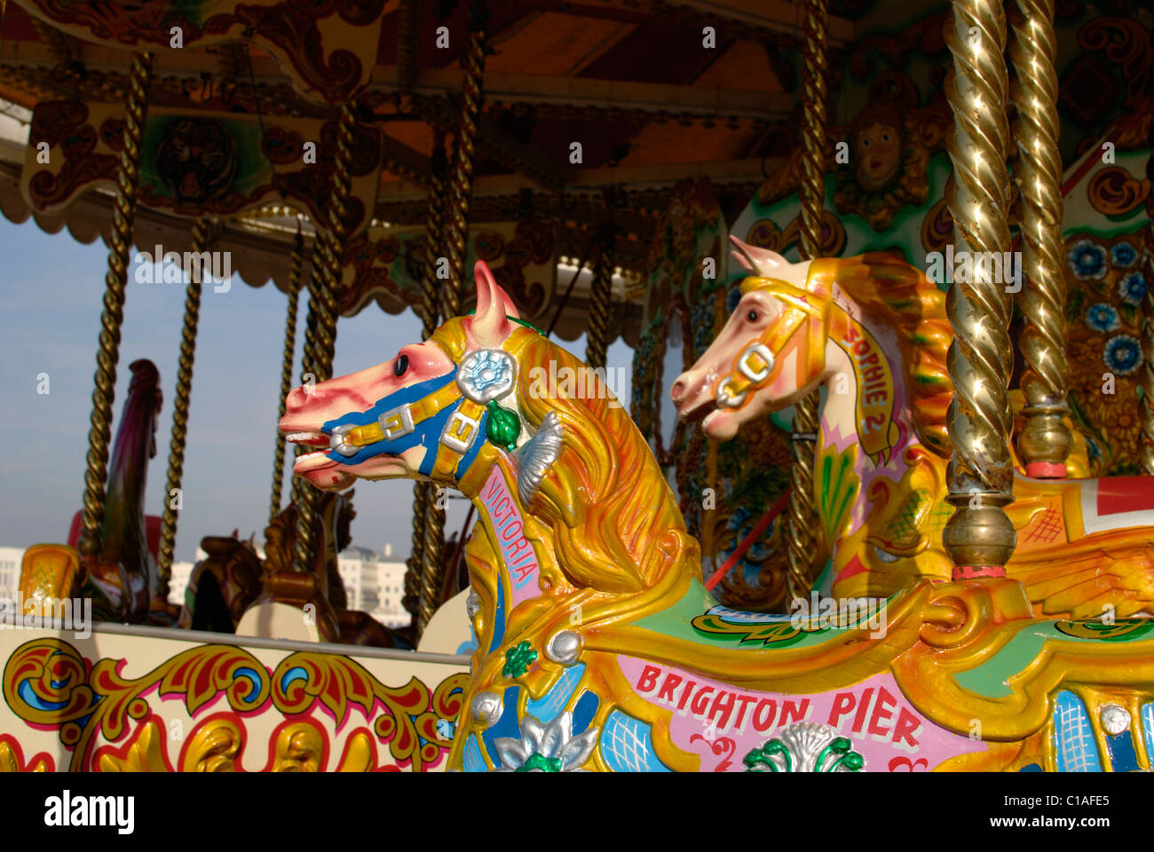 Brightly coloured fairground horse on traditional roundabout. Brighton ...