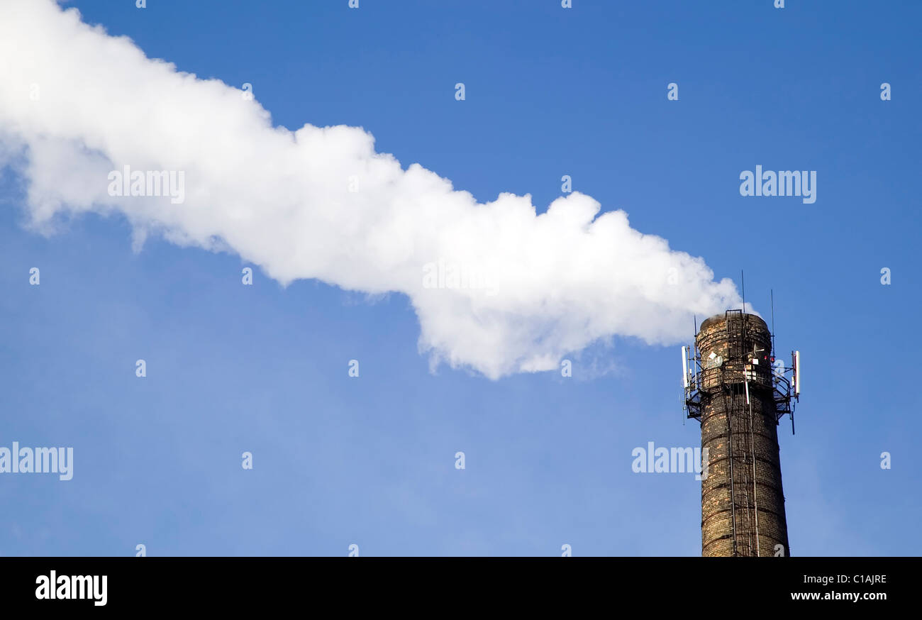 Chimney of factory with smoke on sky background Stock Photo - Alamy