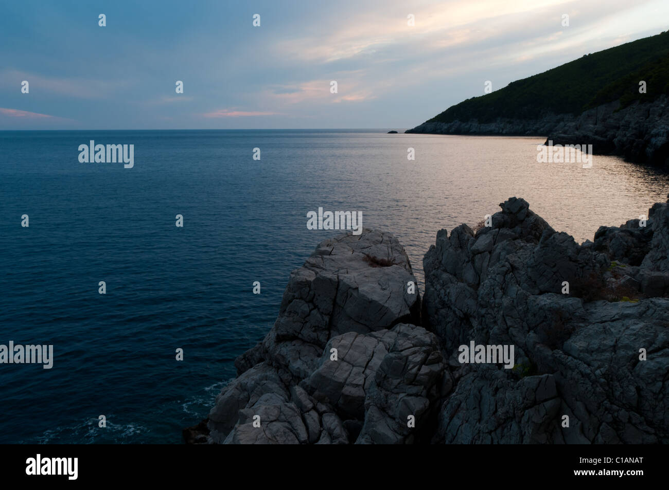 Sunset. Rocky limestone cliffs surround beautiful coast of the Adriatic ...