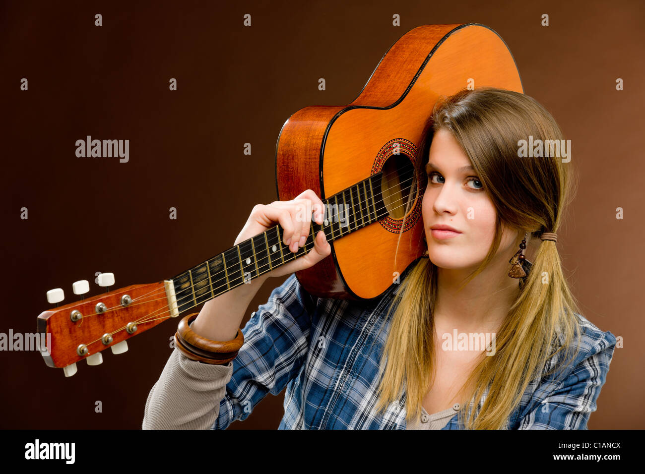 Rock musician - young fashion female model posing with guitar Stock ...