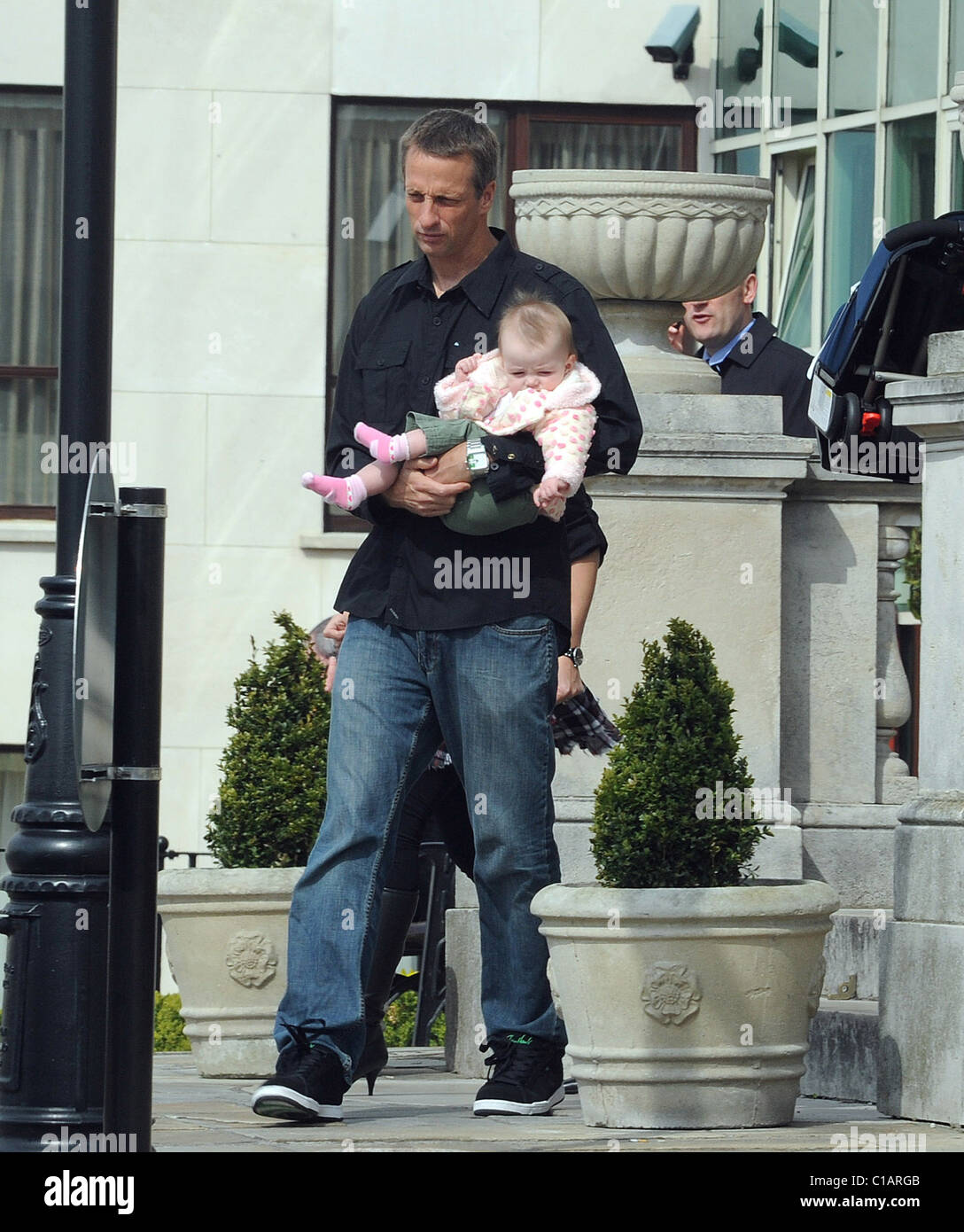 Skateboarder Tony Hawk leaving his hotel with wife Lhotse Hawk and ...