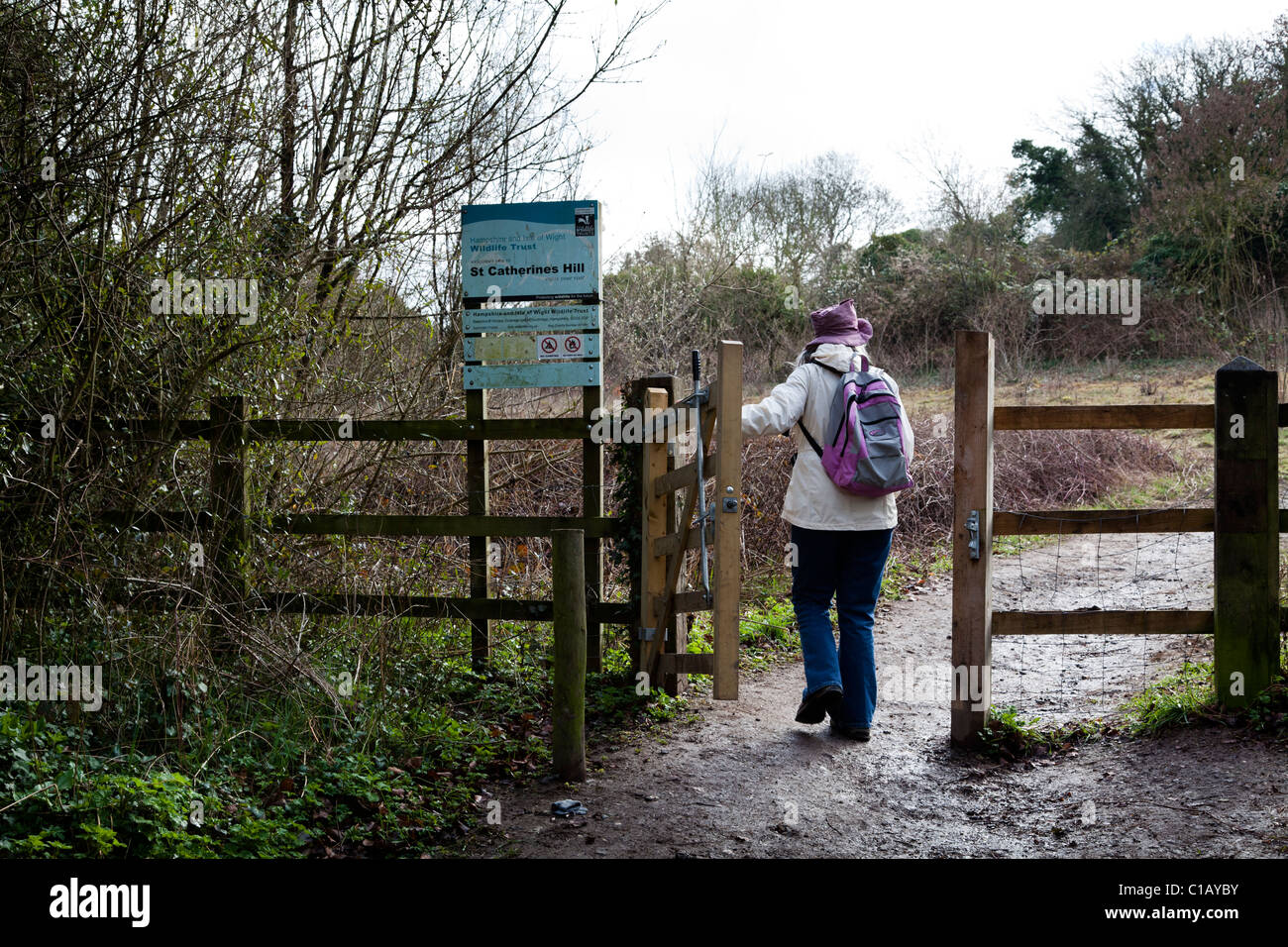 walker passing through gate to St Catherines Hill, Winchester Stock ...