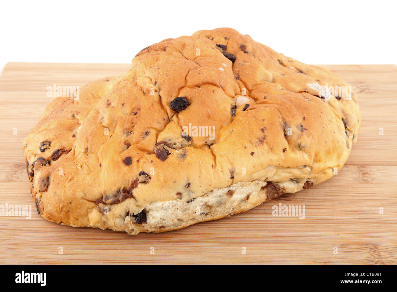 raising bread on wooden cutting board over white background Stock Photo ...