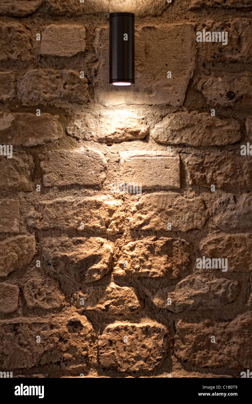 Downlighter shining on a stone wall Stock Photo - Alamy