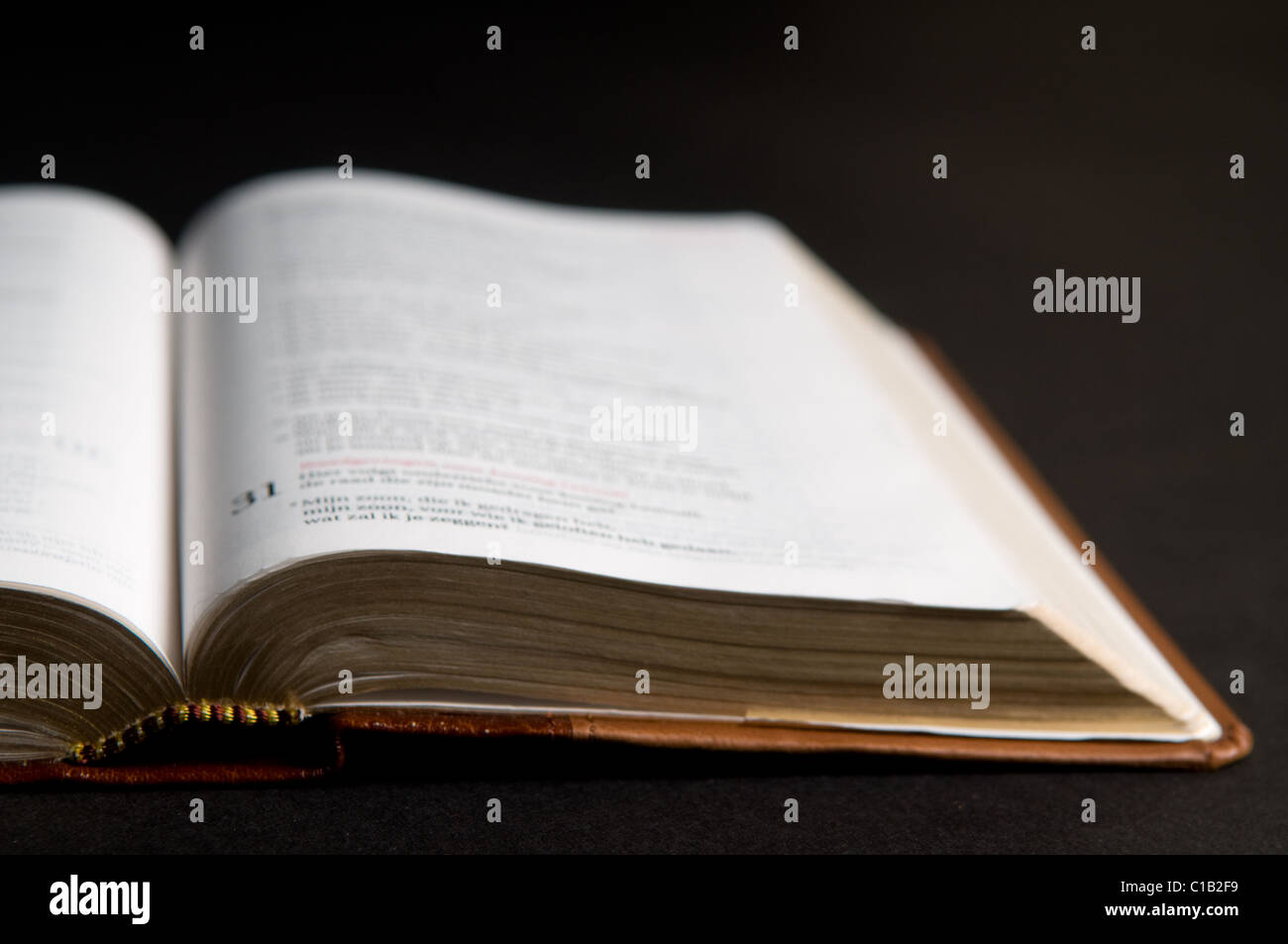 Bible on black background Stock Photo - Alamy