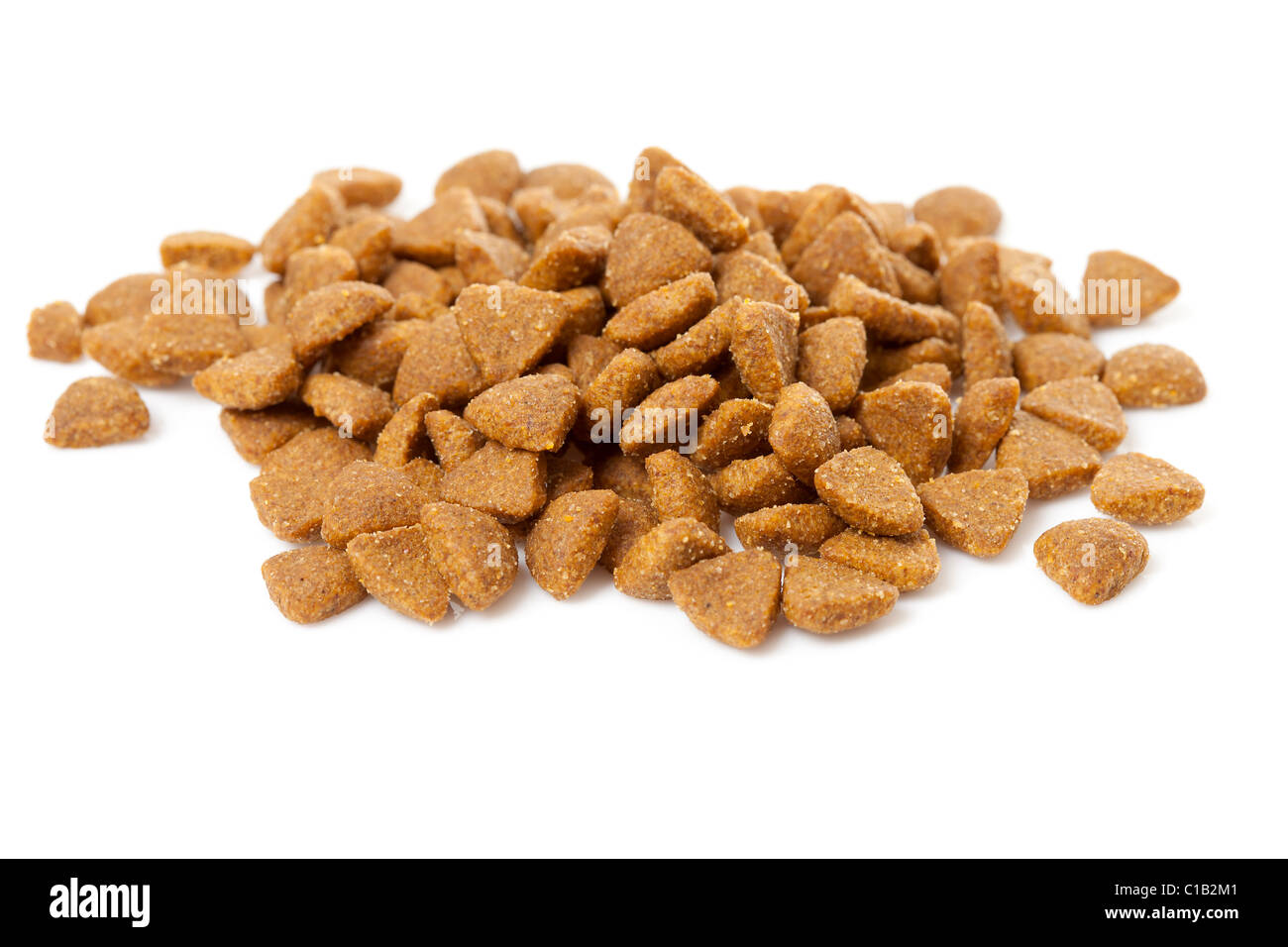 pile of dry cat food over white background Stock Photo - Alamy