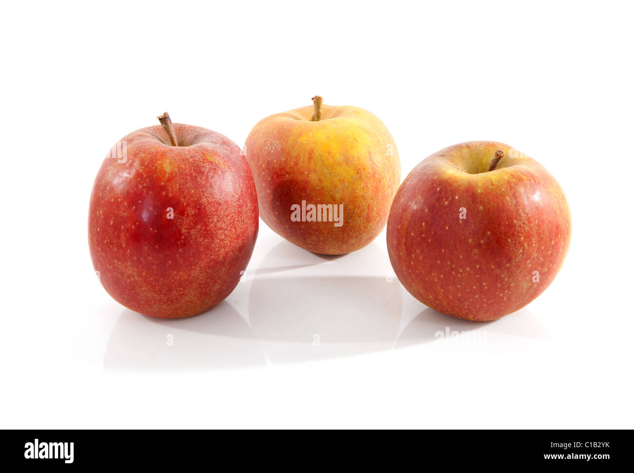 three red apples over white background Stock Photo - Alamy