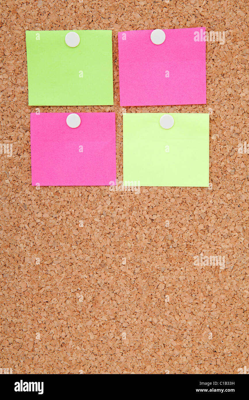 Blank sticky notes pinned on cork memo board in closeup Stock Photo - Alamy