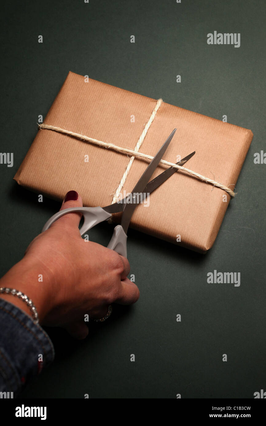 Wrapped parcel and scissors hi-res stock photography and images - Alamy