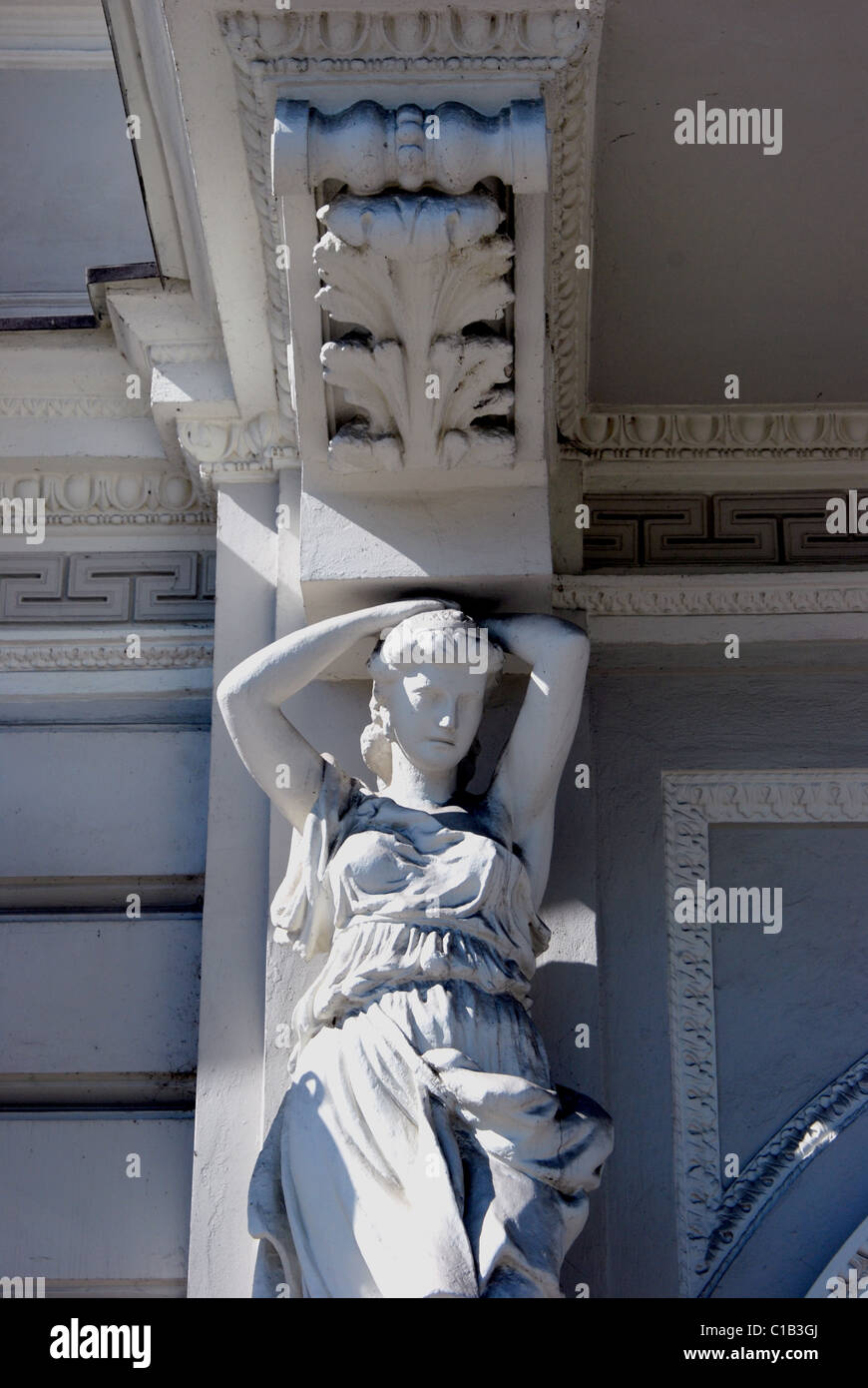 white statue of women holding building roof Stock Photo - Alamy