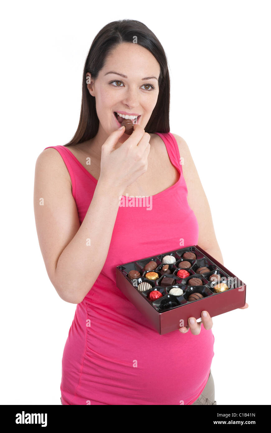 Woman eating chocolate Stock Photo - Alamy