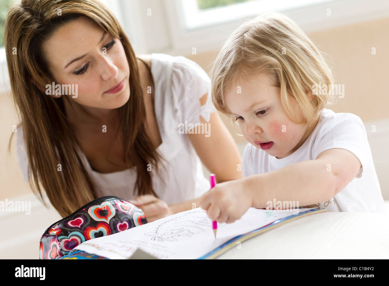 Mother and child writing/drawing Stock Photo - Alamy