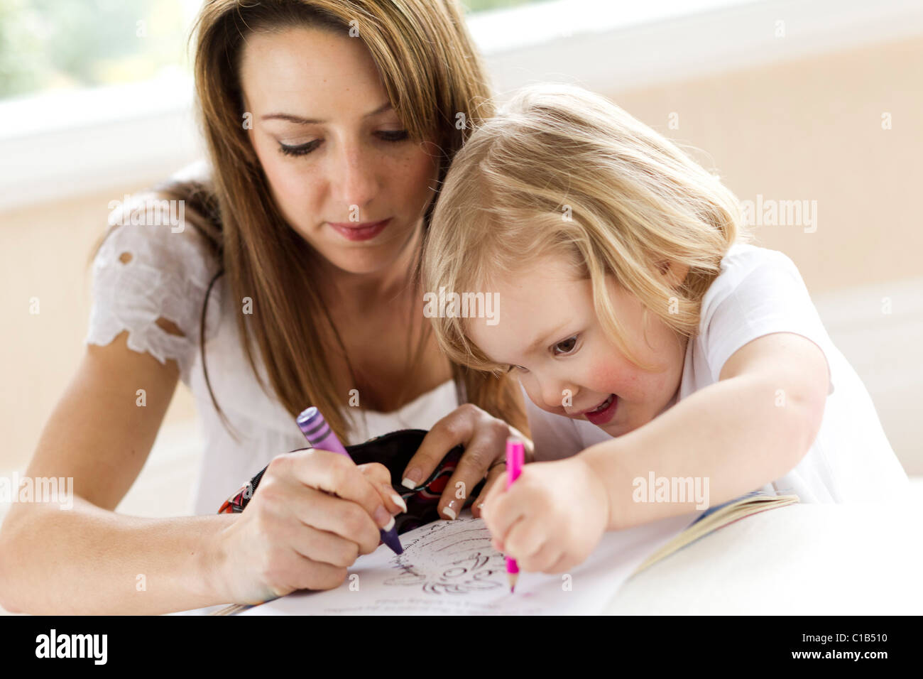 Mother and child writing/drawing Stock Photo - Alamy
