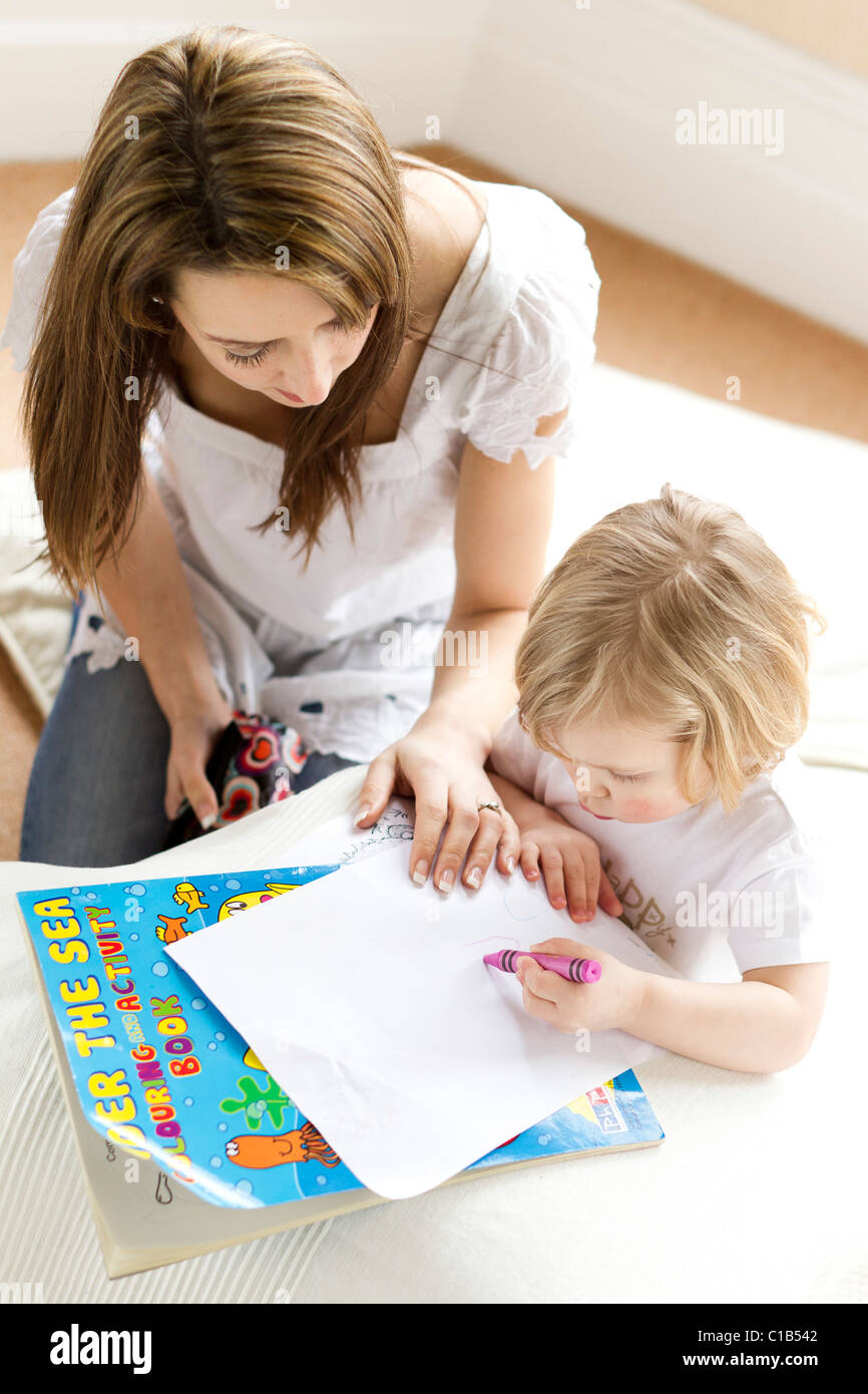 Mother and child writing/drawing Stock Photo - Alamy