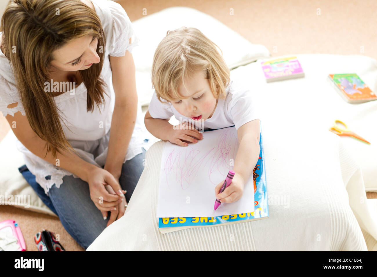 Mother and child writing/drawing Stock Photo - Alamy