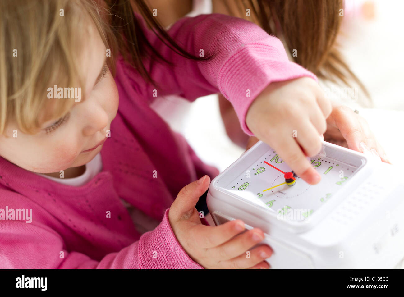 Mother and child with clock Stock Photo - Alamy