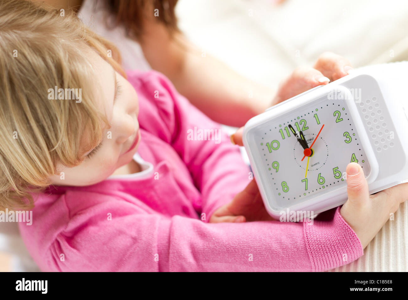 Mother and child with clock Stock Photo - Alamy