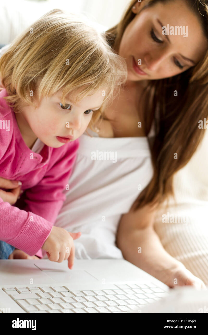 Mother and daughter using computer Stock Photo - Alamy