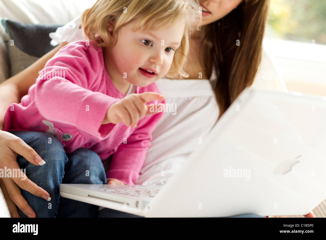 Mother and daughter using computer Stock Photo - Alamy