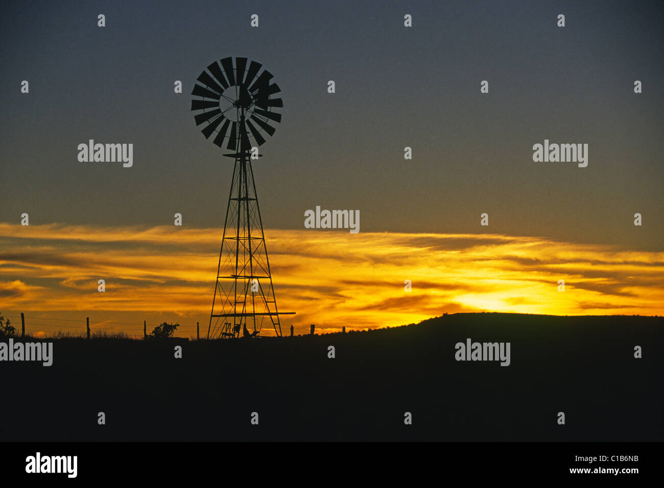An old windmill on a cattle ranch in West Texas at sunset Stock Photo ...
