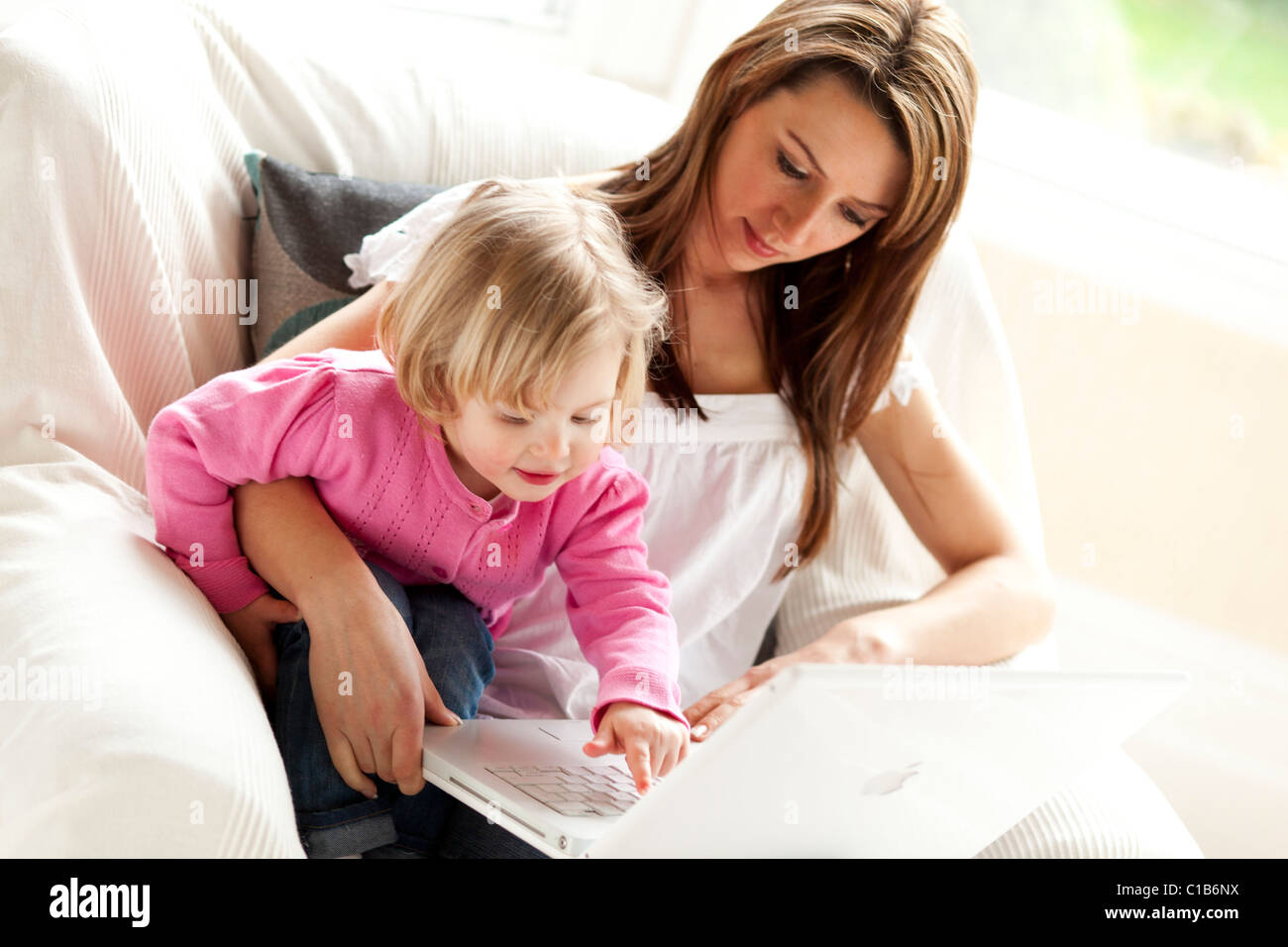 Mother and daughter using computer Stock Photo - Alamy