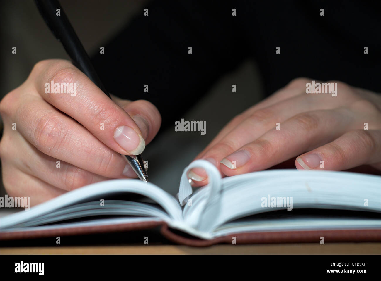 Young girl is making notes in her diary Stock Photo - Alamy