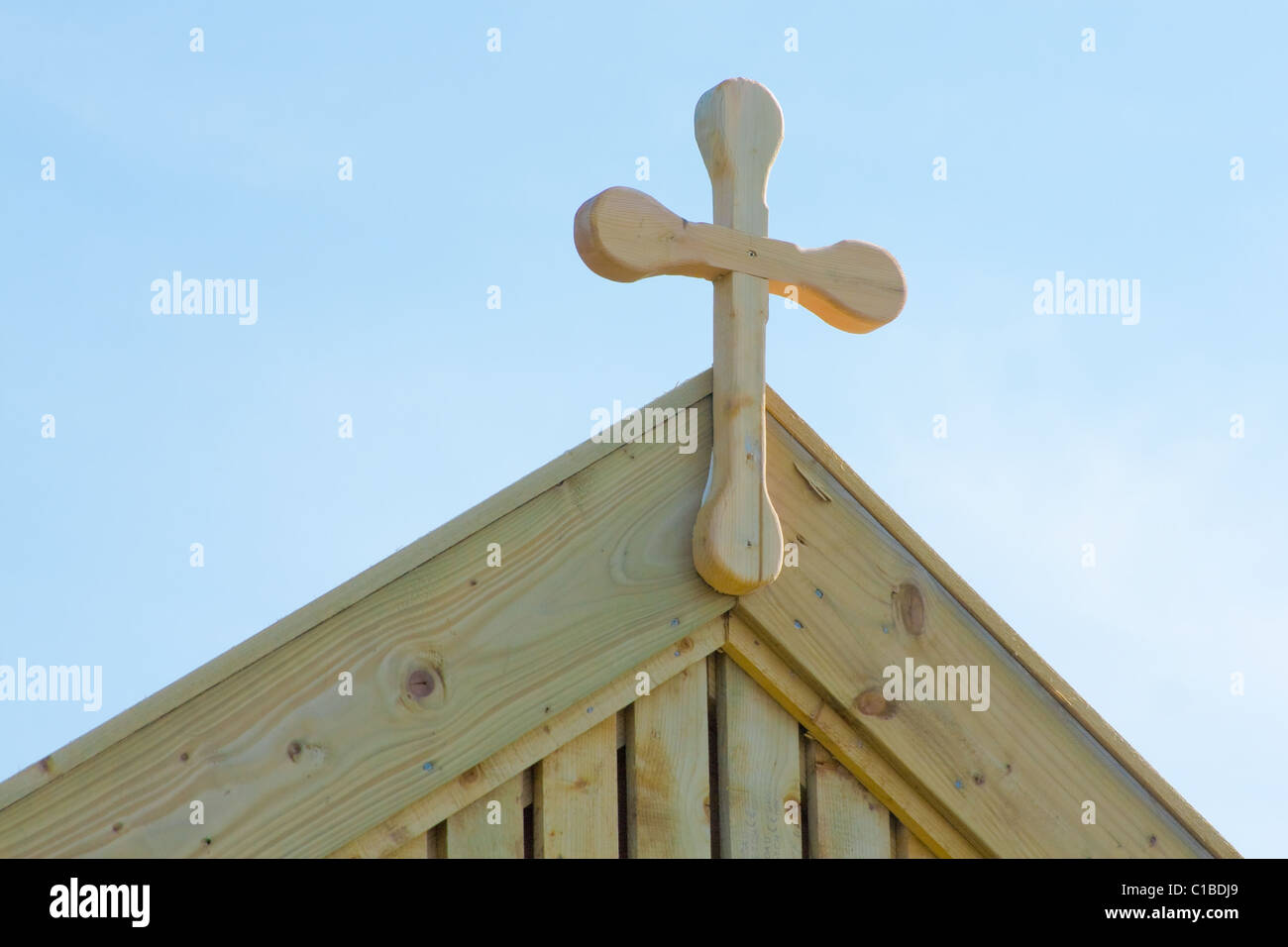 Modern wooden cross on a roof Stock Photo - Alamy