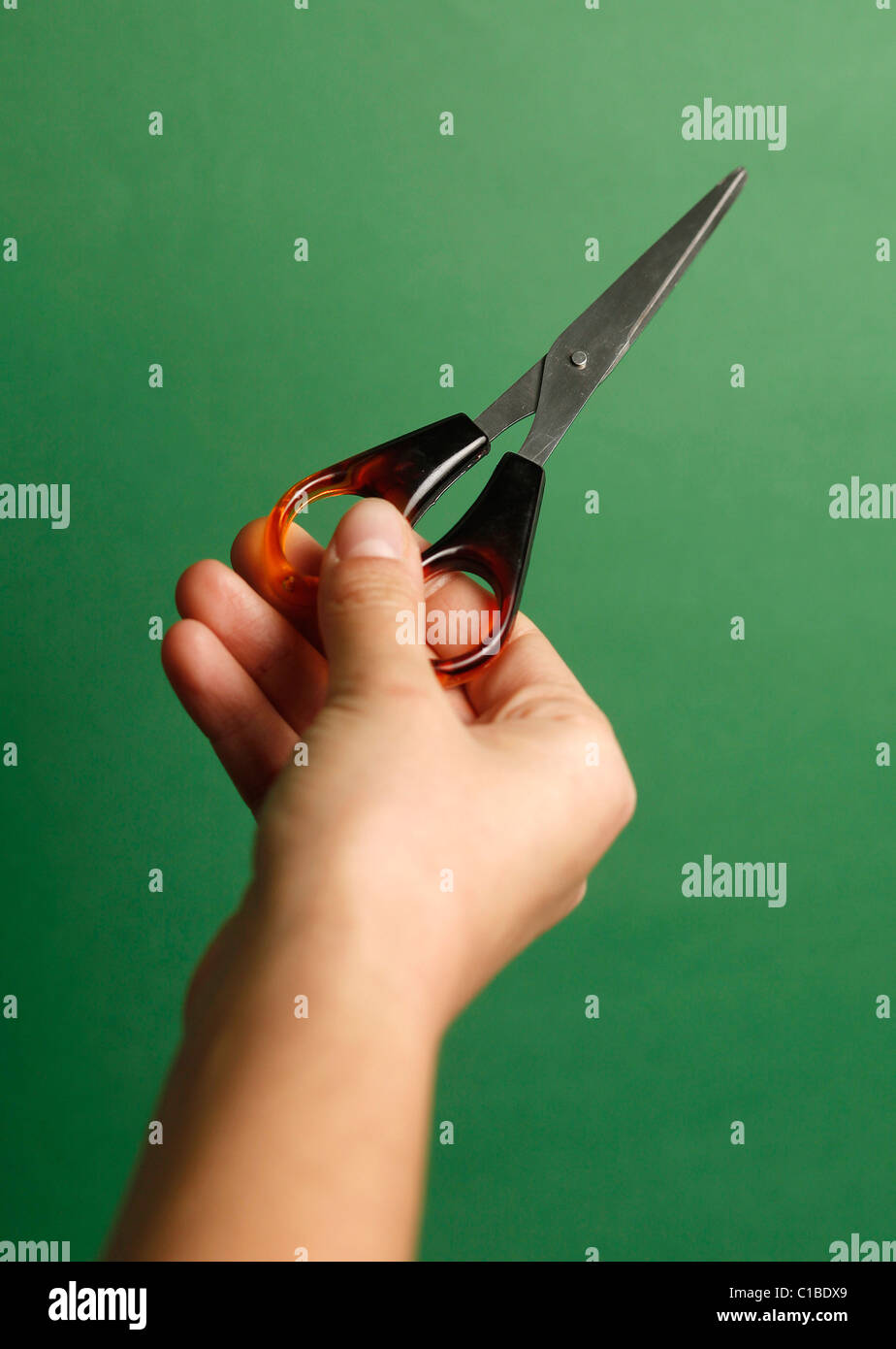 Hand with scissors Stock Photo - Alamy