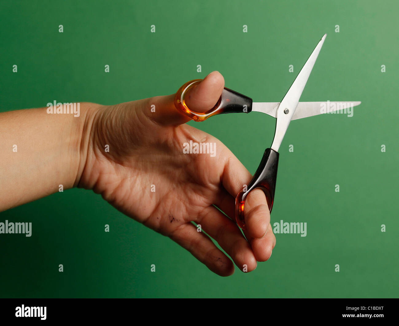 Hand with scissors Stock Photo - Alamy
