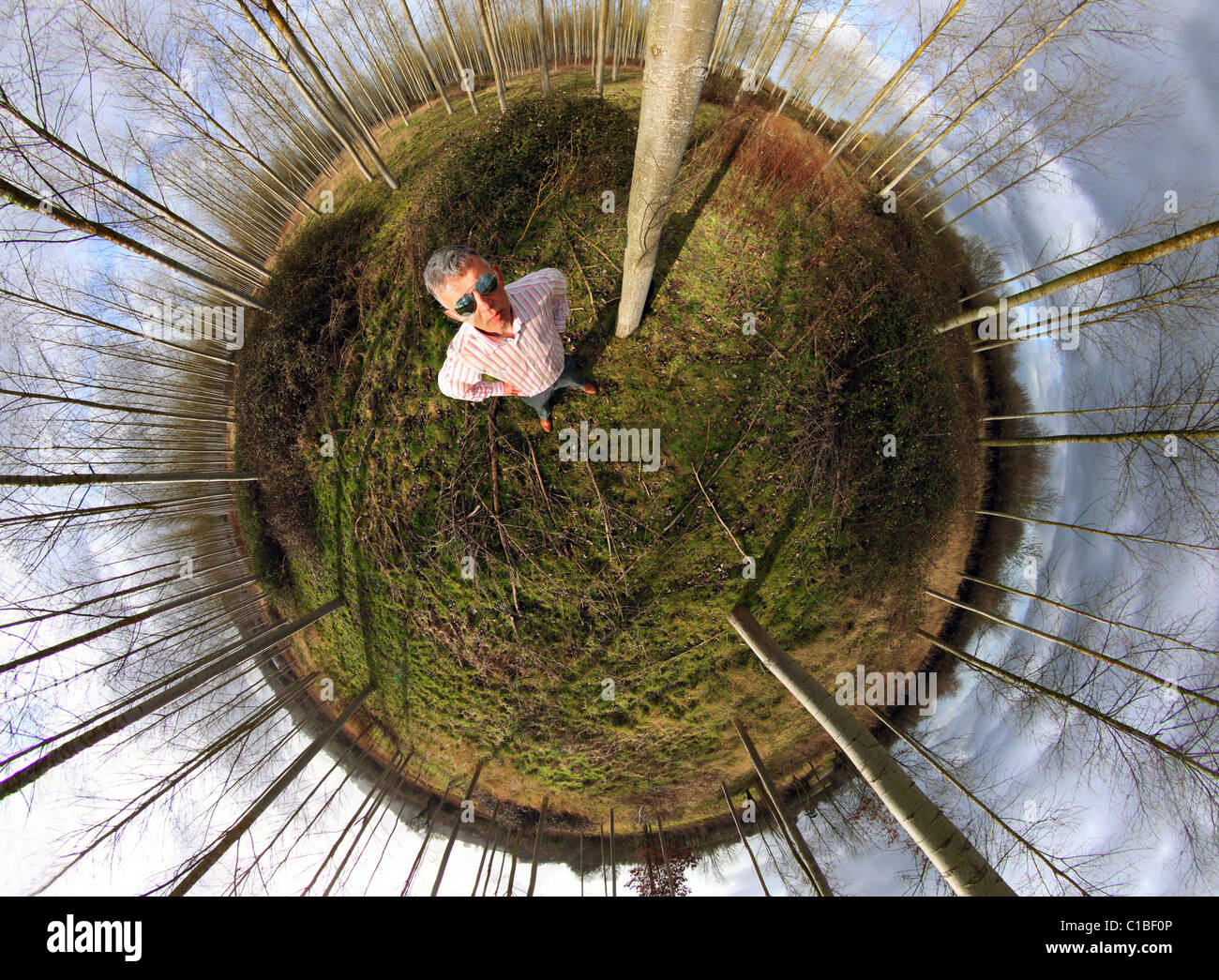 man looking up at camera in a small planet panorama Stock Photo - Alamy