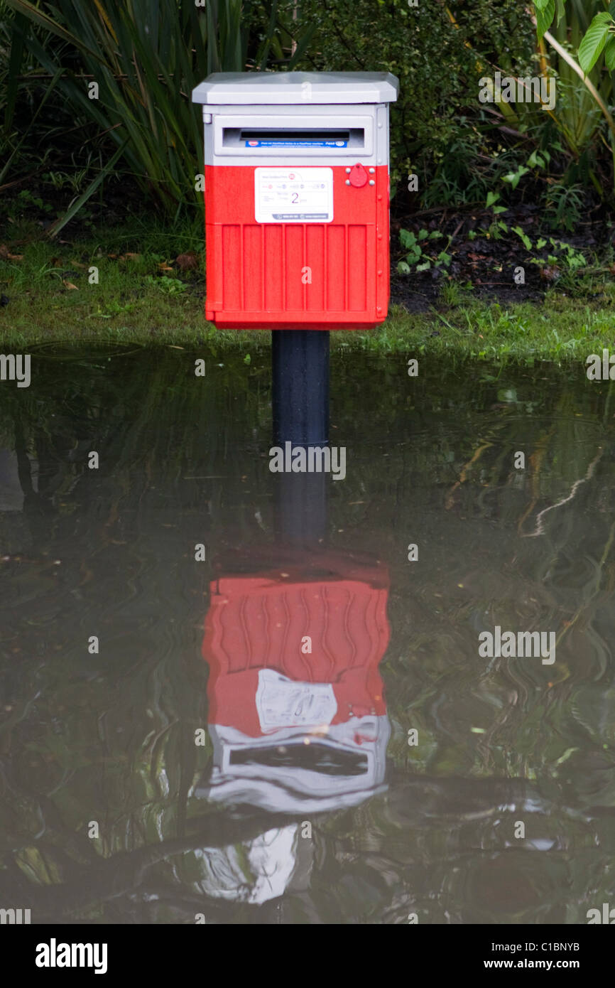 A post box are flooded as heavy rainfall causes local disruption to ...