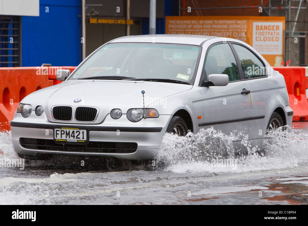 A car drives through water on a flooded road Stock Photo - Alamy