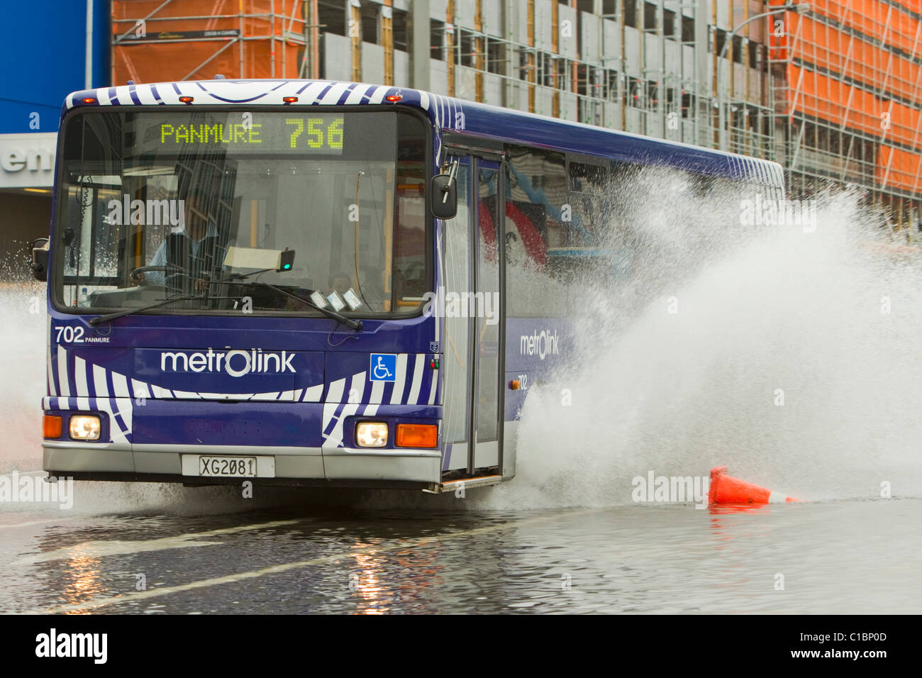 A bus drives through water on a flooded road Stock Photo - Alamy