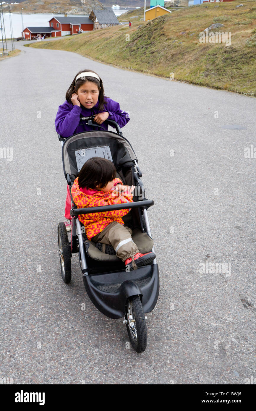 Girl pushing a baby stroller, Narsaq, South Greenland Stock Photo - Alamy