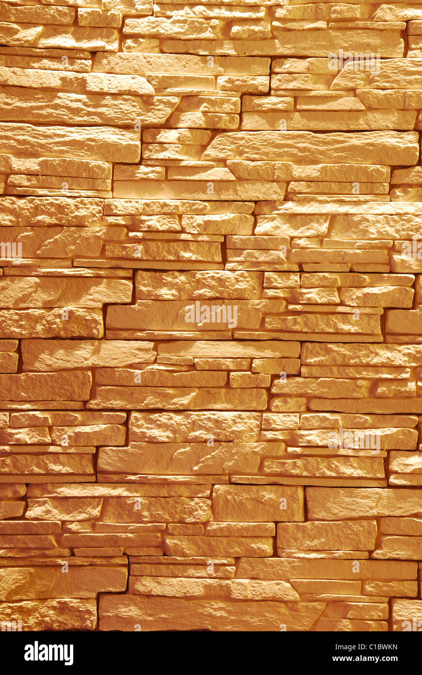 Unshaped stone wall (illuminated Stock Photo - Alamy