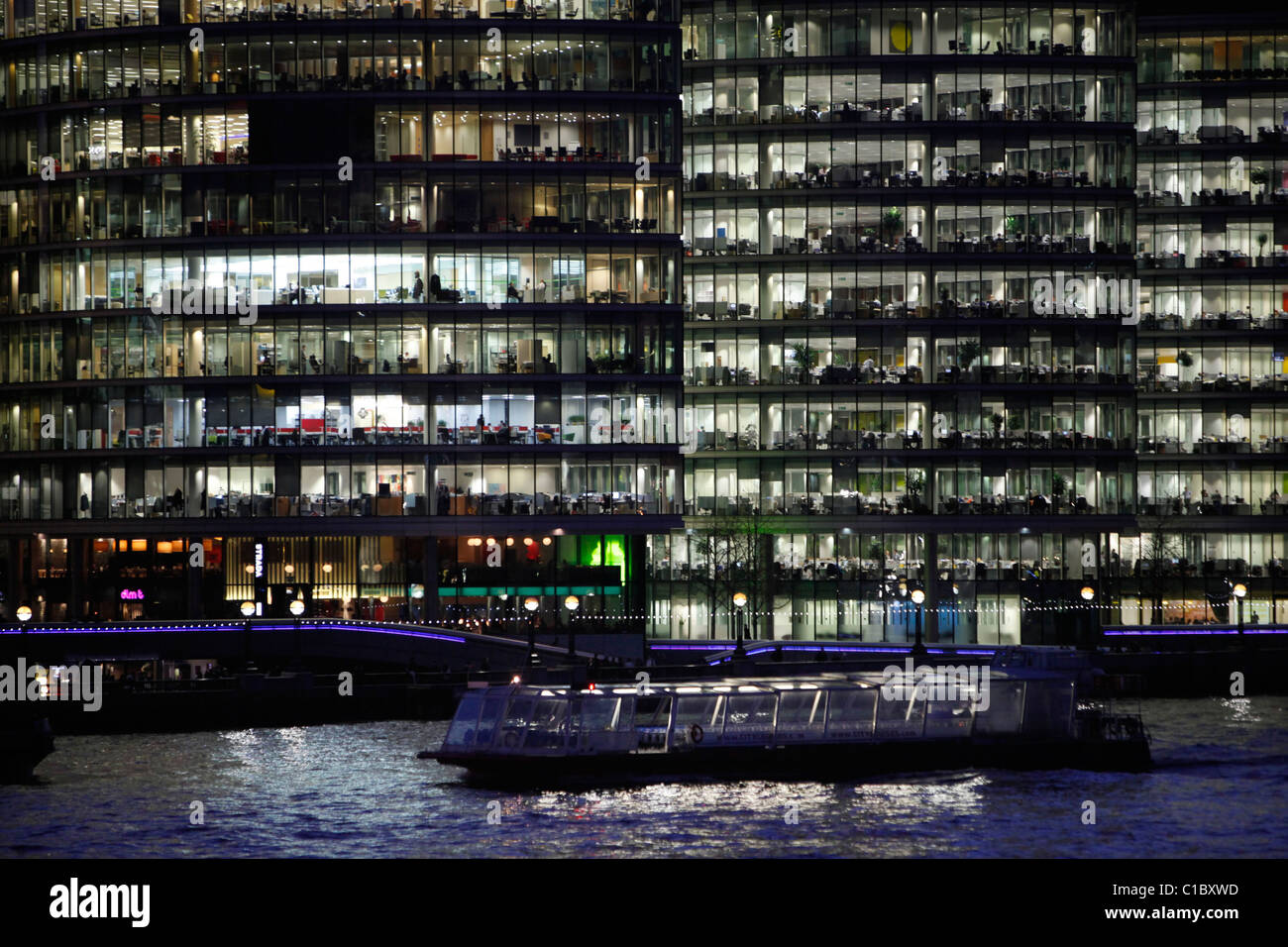 Office buildings at More London lit up at night. This new business ...