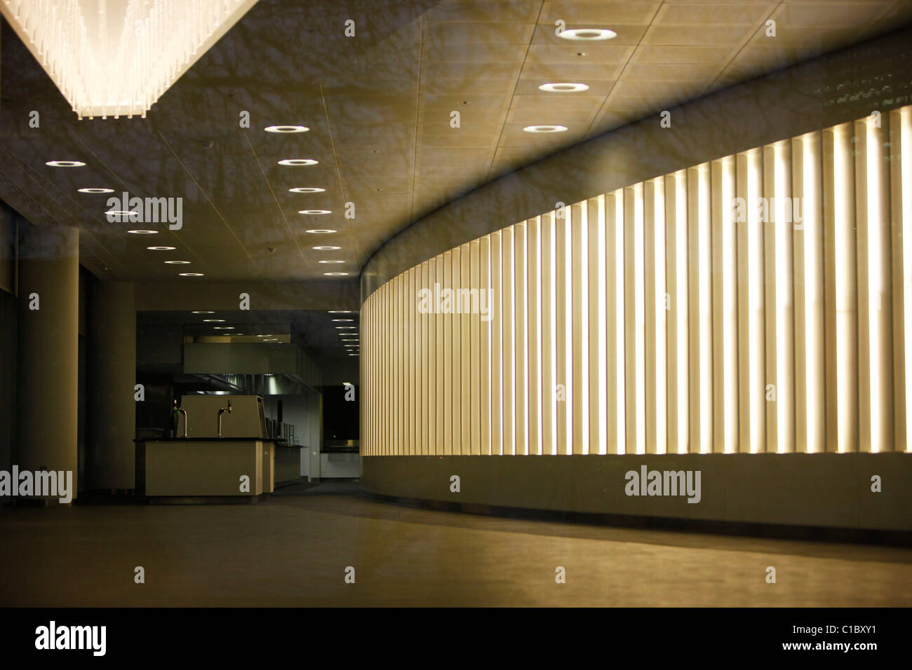 Interior of a new office building with dramatic lighting along one wall ...