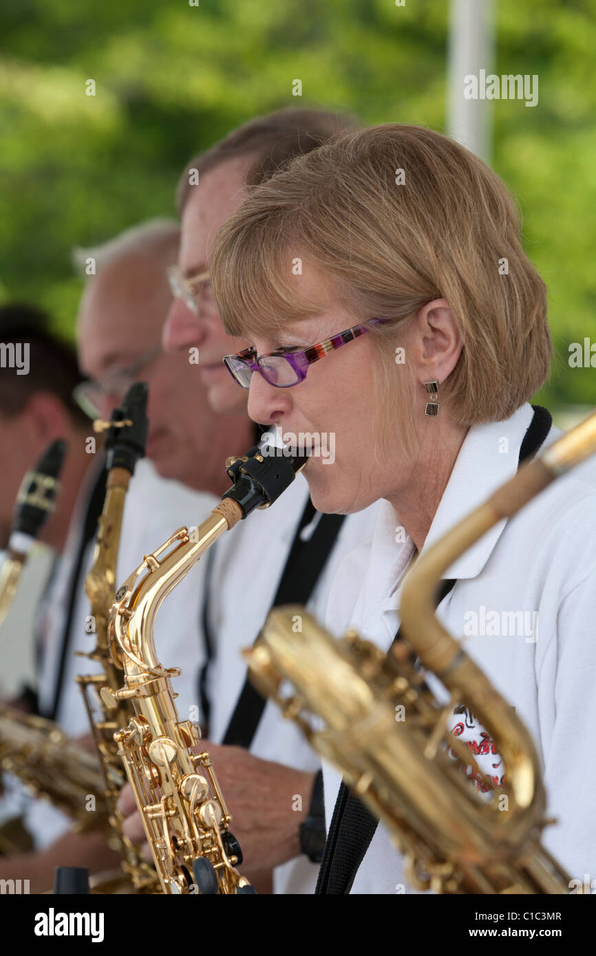 Woman playing sax at public concert Stock Photo - Alamy
