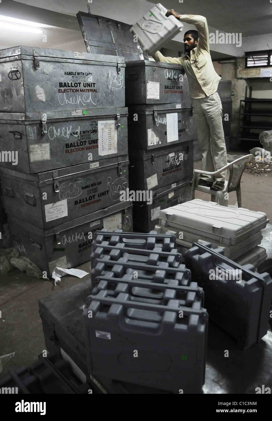 Indian workers prepare to pack cases of Electronic Voting Machines ...