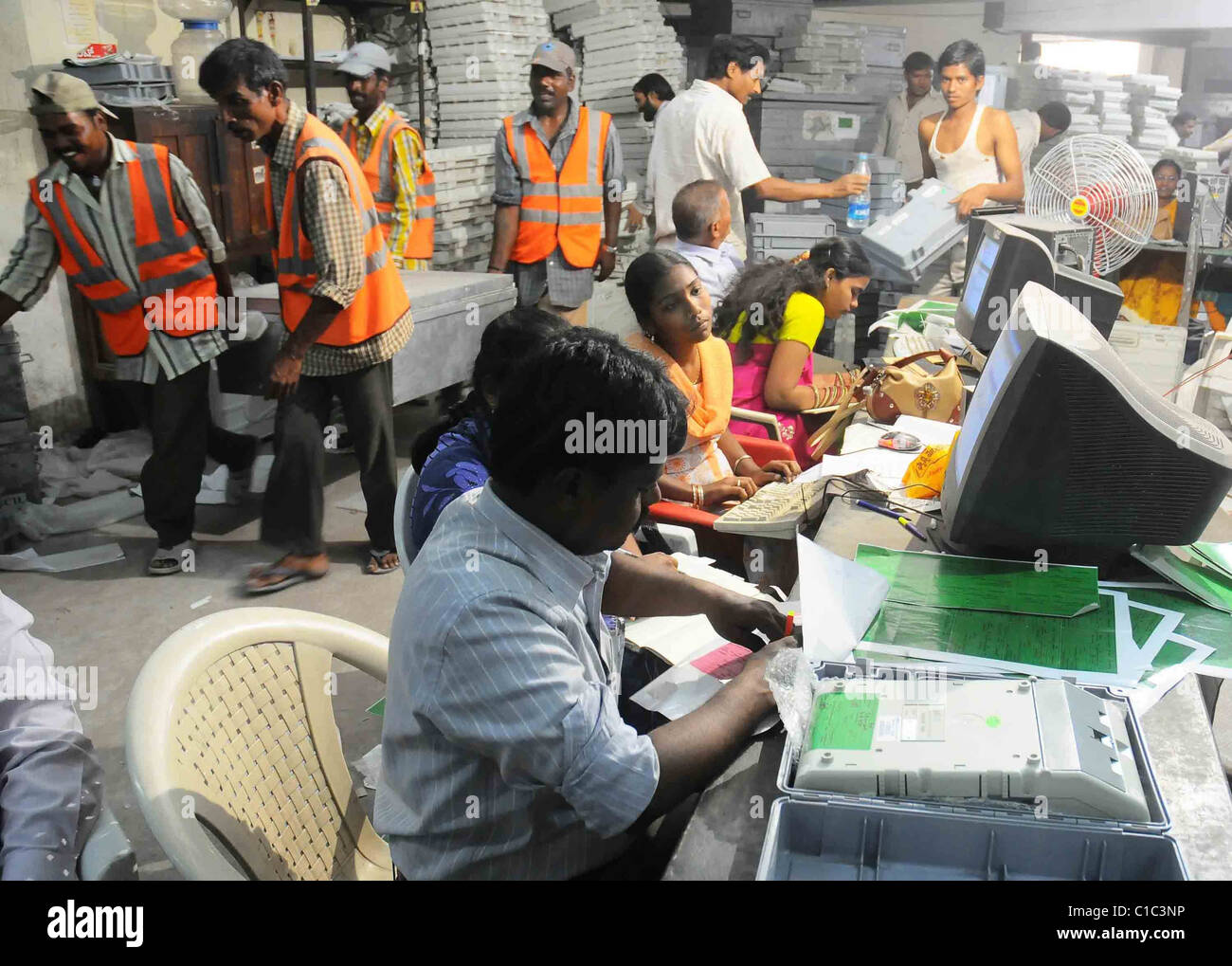 Indian workers prepare to pack cases of Electronic Voting Machines ...