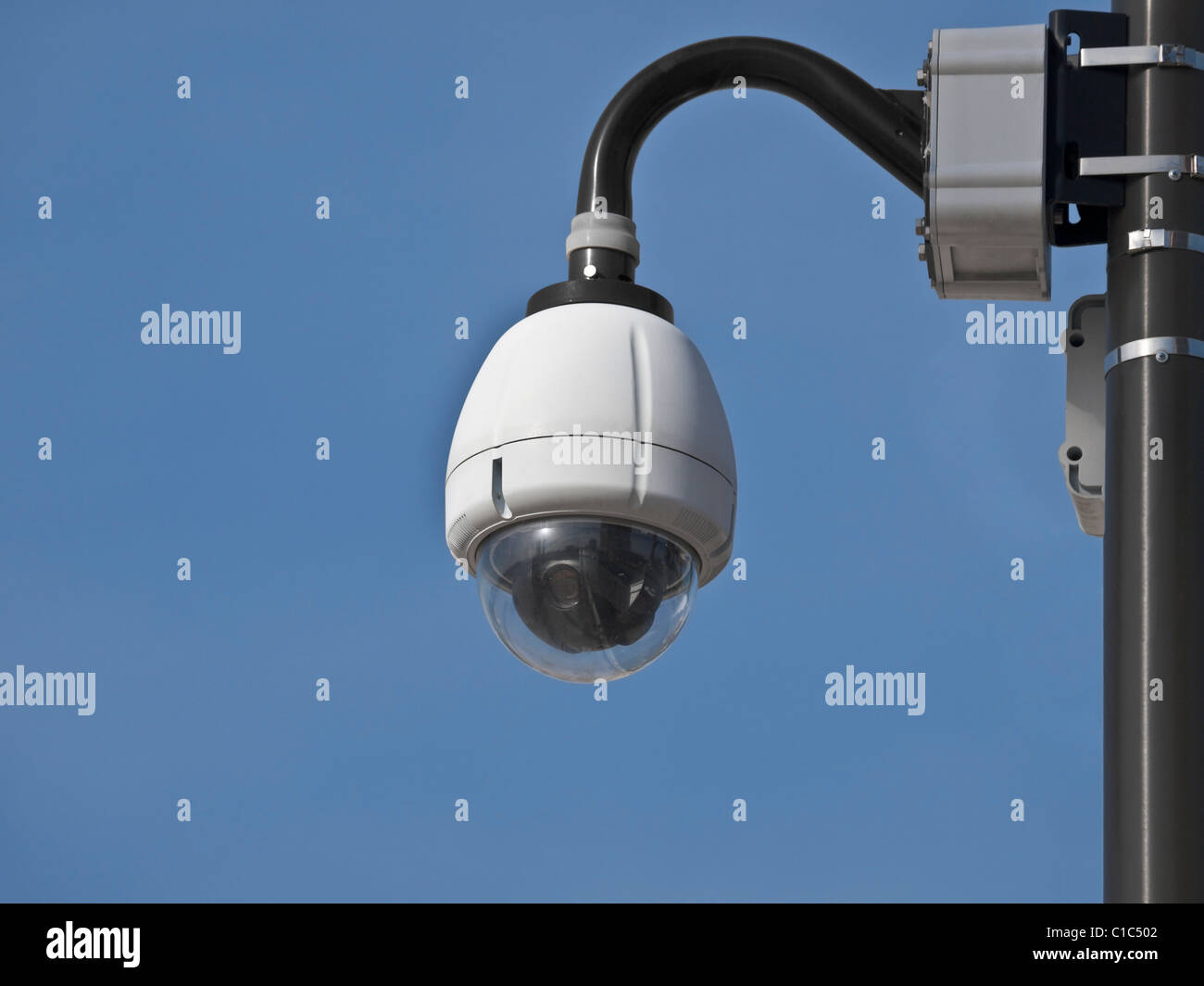 Modern outdoor security camera on a tall light poll Stock Photo - Alamy
